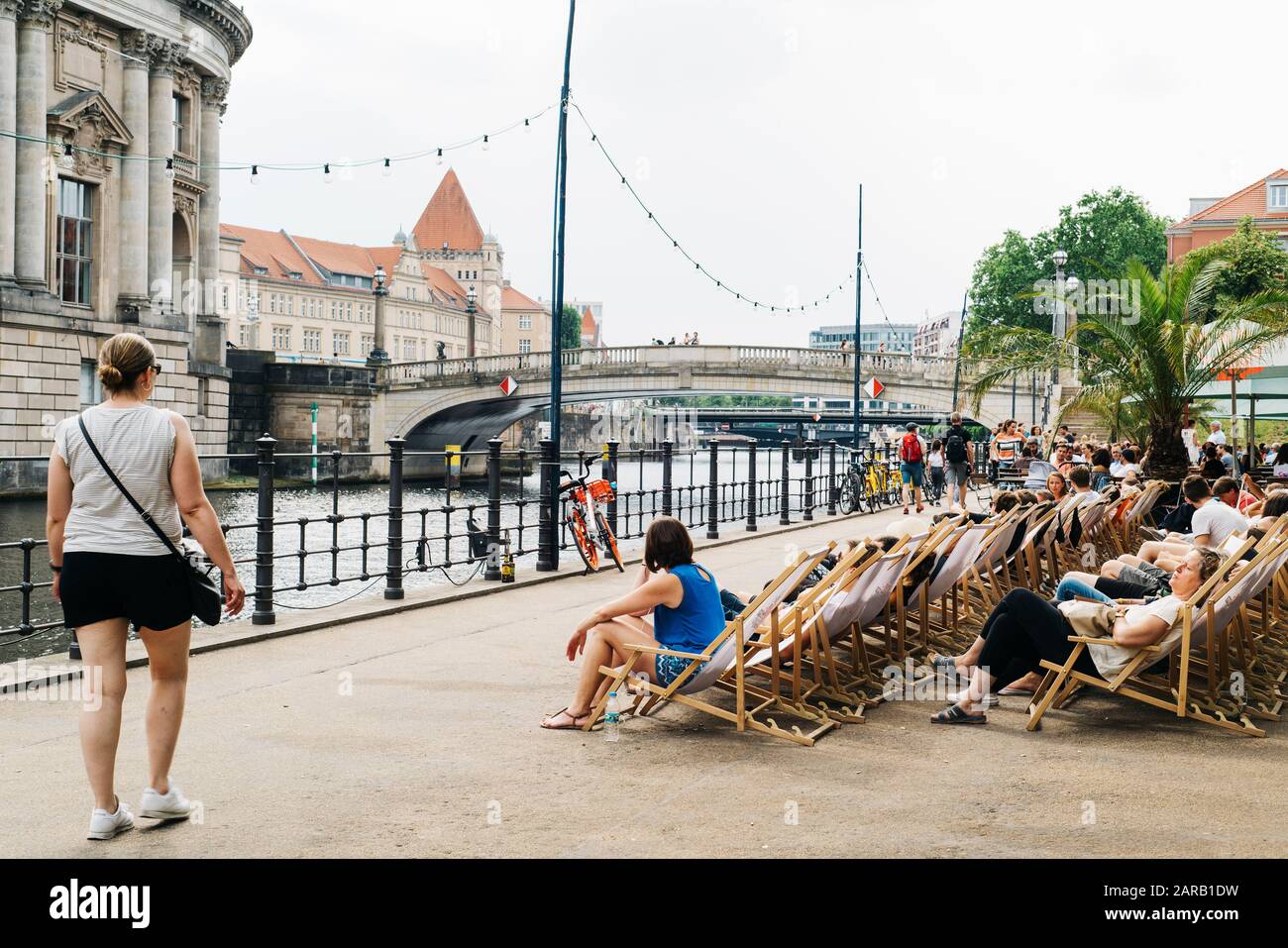 BERLIN, GERMANY - MAY 27, 2018: People relaxing sitting on deck chairs ...