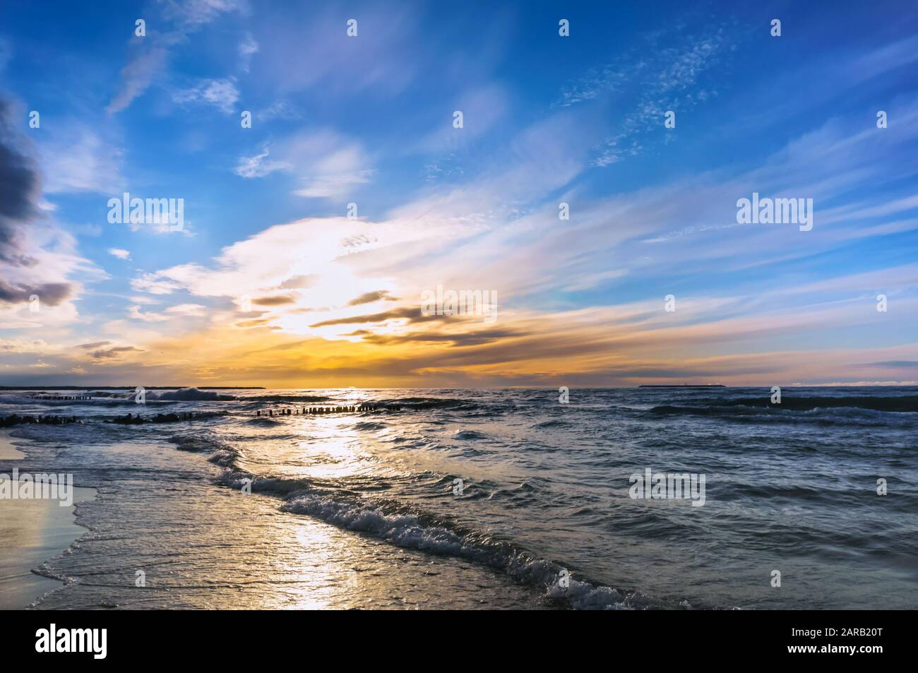 Sunset over the sea. Reflection of sunlight in the sea waves. Red sky ...