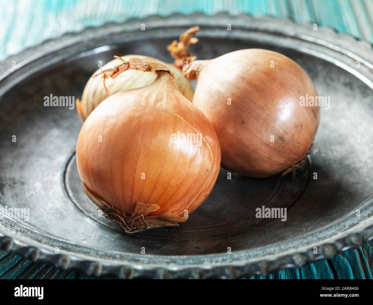 Large onions on a metal plate Stock Photo - Alamy
