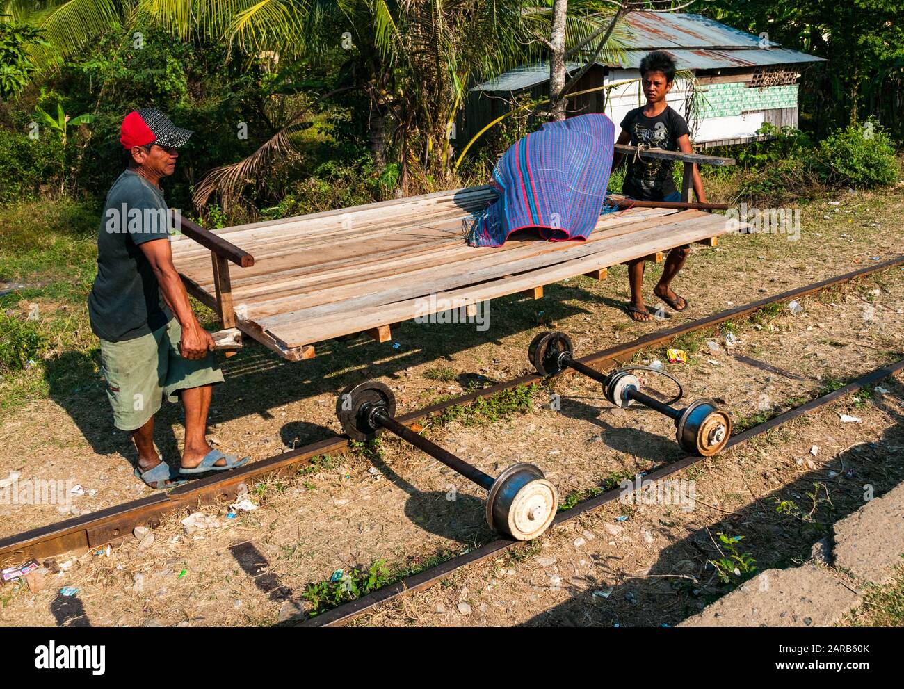 Cambodian train drivers remounting the bamboo train on the tracks when ...