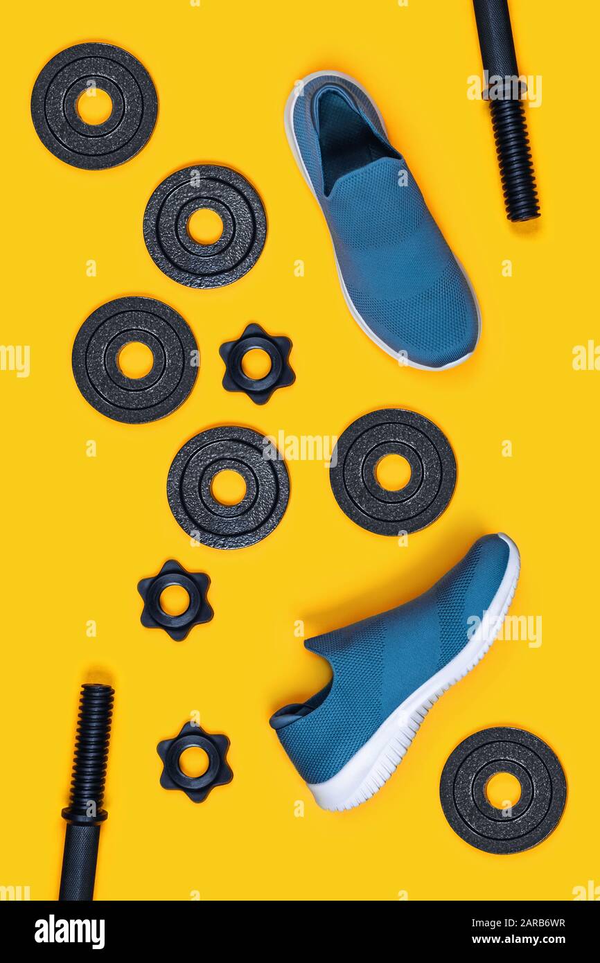 Sports vertical background. Dumbbells and Sneakers on yellow background ...