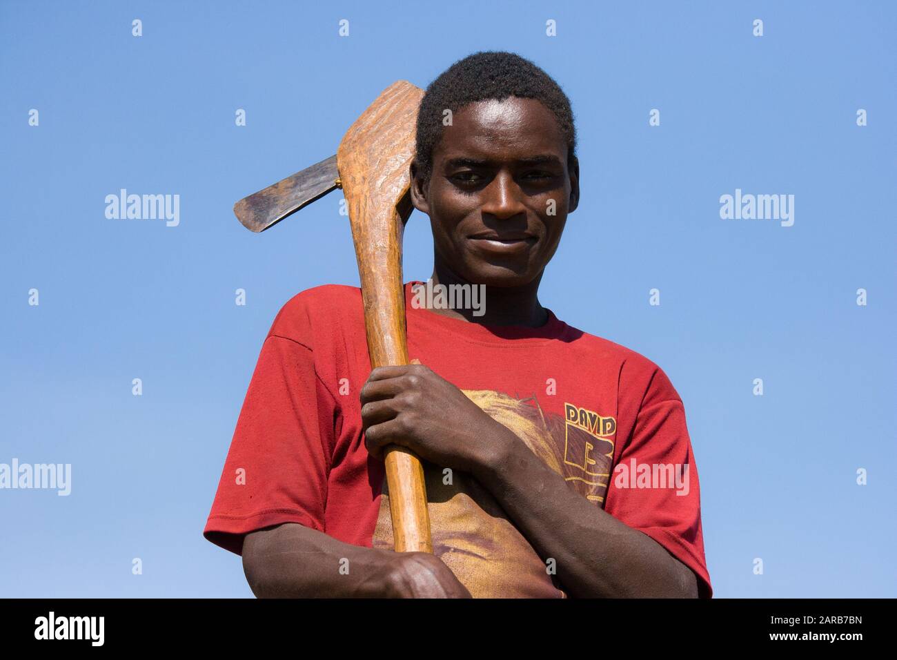 Young man from Konso tribe holding African tribal axe, Omo Region ...