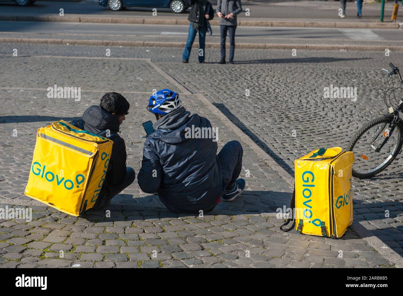 Rome, 17/01/2020: young boy glovo rider making delivery on his bike ...