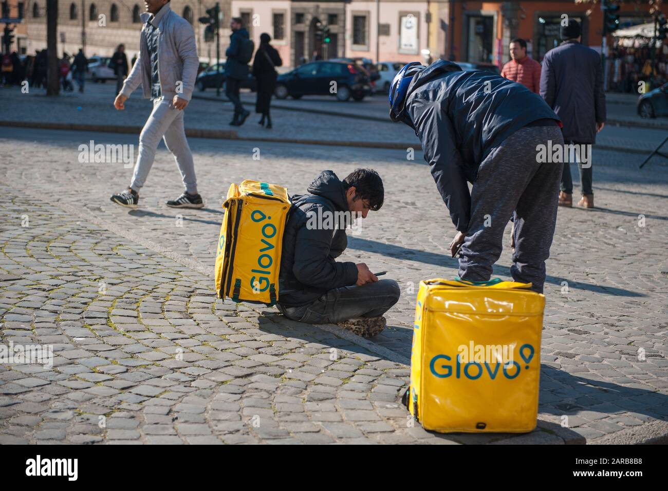 Rome, 17/01/2020: young boy glovo rider making delivery on his bike ...