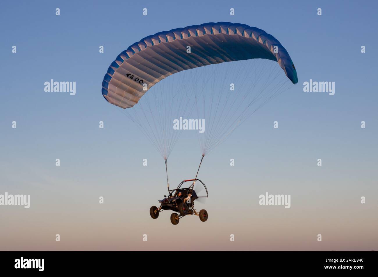flying car flying, with a blue parachute wing Stock Photo - Alamy