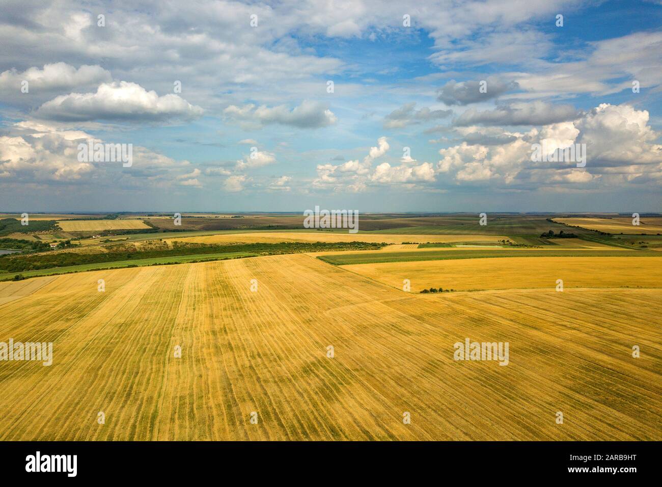 Aerial rural landscape with yellow patched agriculture fields and blue ...