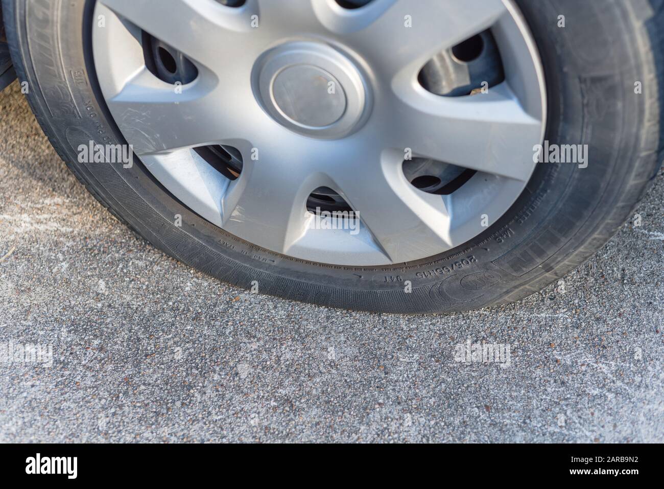 Flat Tire Driveway Rear View Of Flat Tire On Green Car On Driveway Of