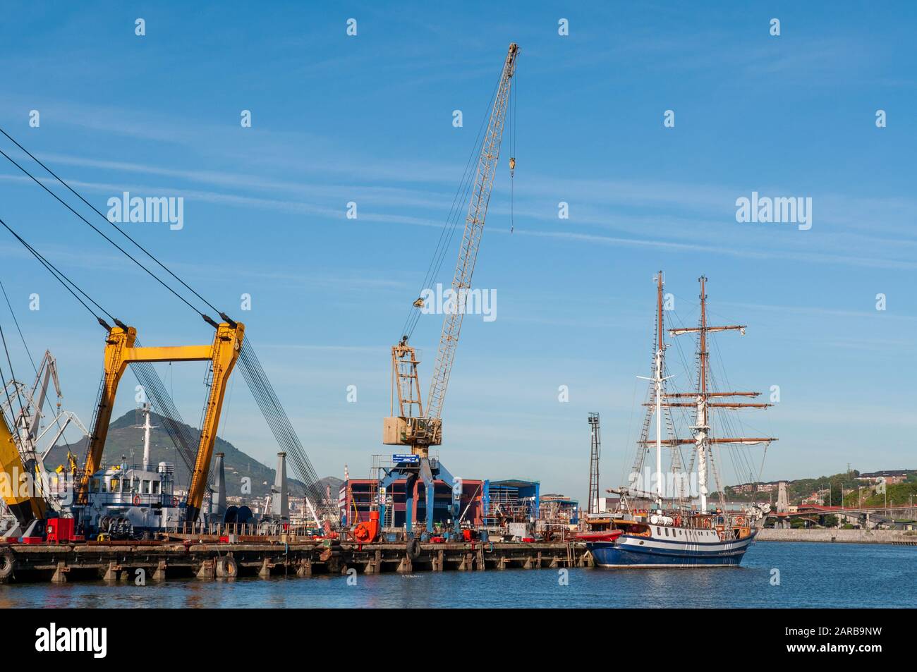 Yellow towers crane at Celaya shipyards in the River Nervion in Erandio ...