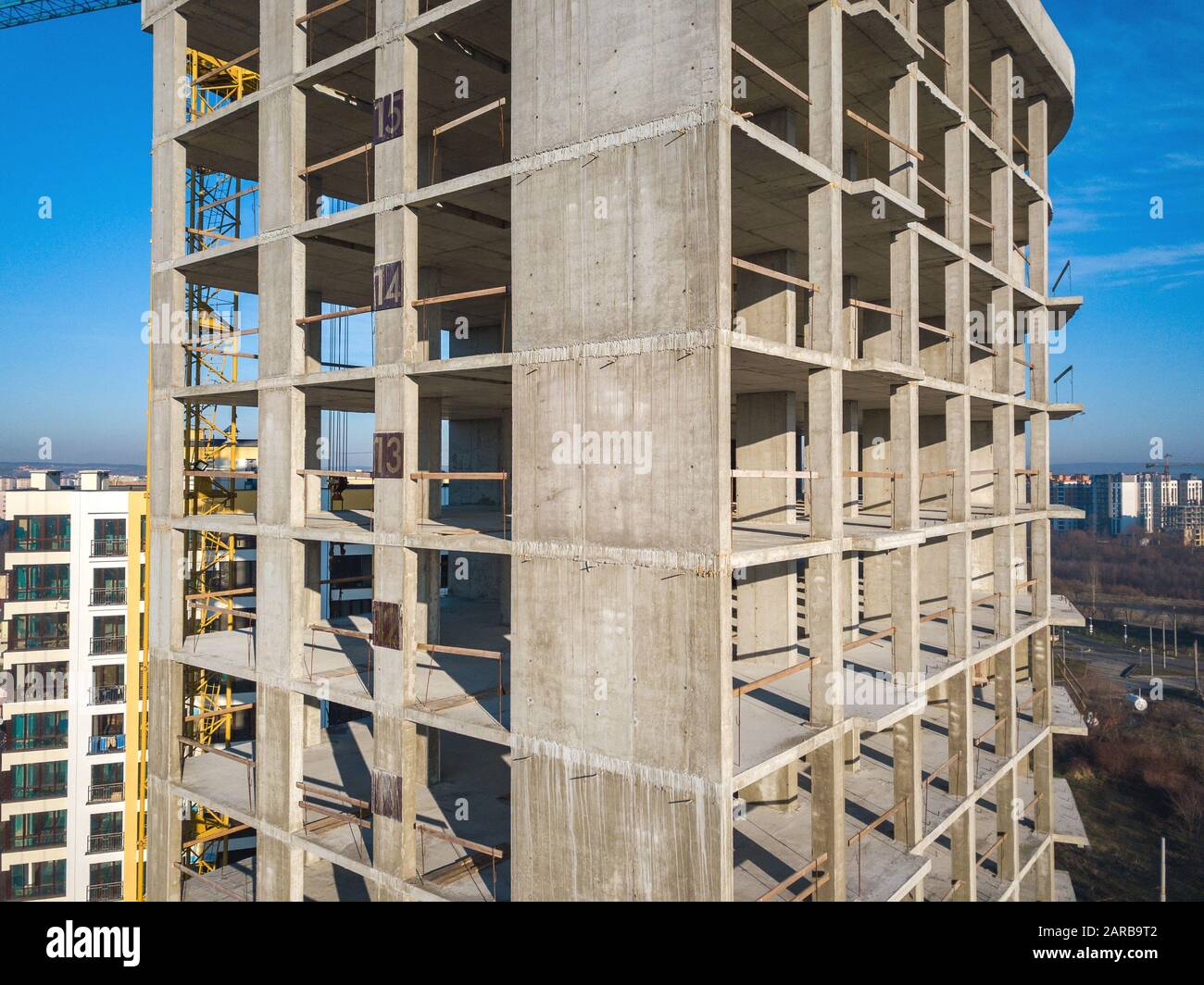 Aerial view of concrete frame of tall apartment building under ...