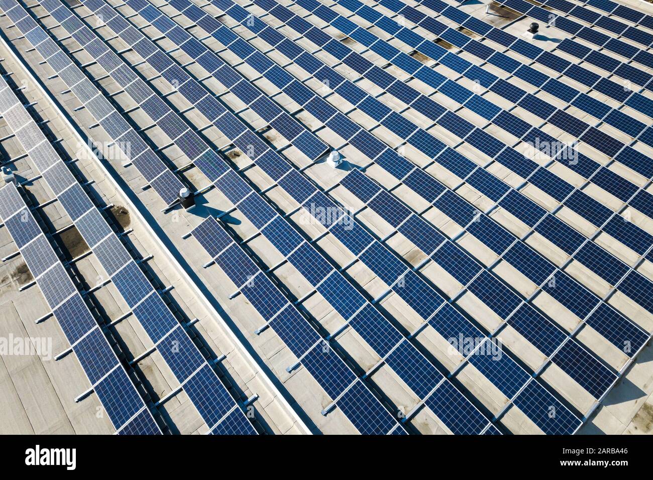 Aerial view of many photo voltaic solar panels mounted of industrial ...