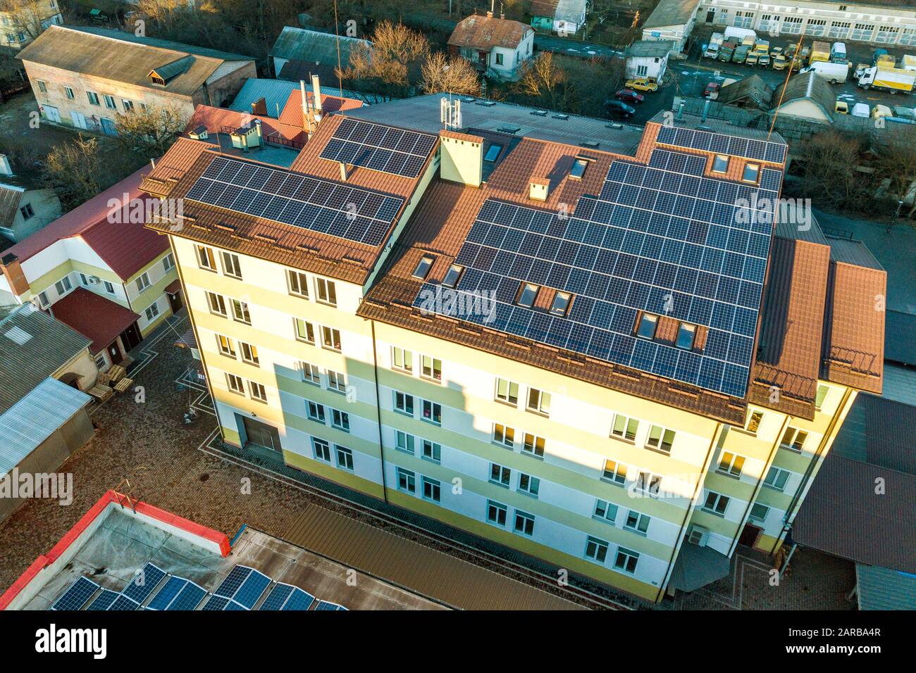 Aerial view of many photo voltaic solar panels mounted of industrial ...