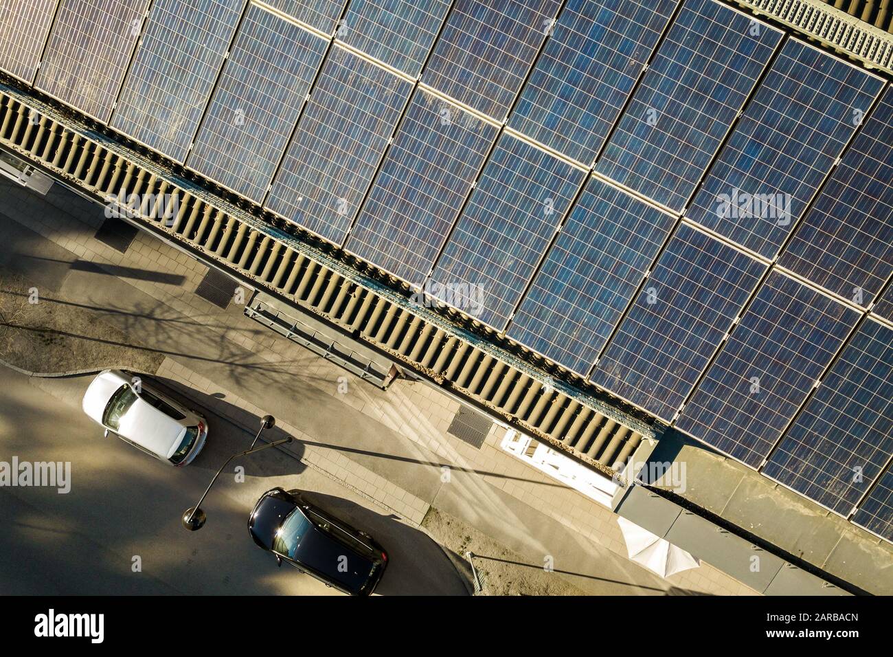 Aerial view of solar photovoltaic panels on a roof top of residential ...