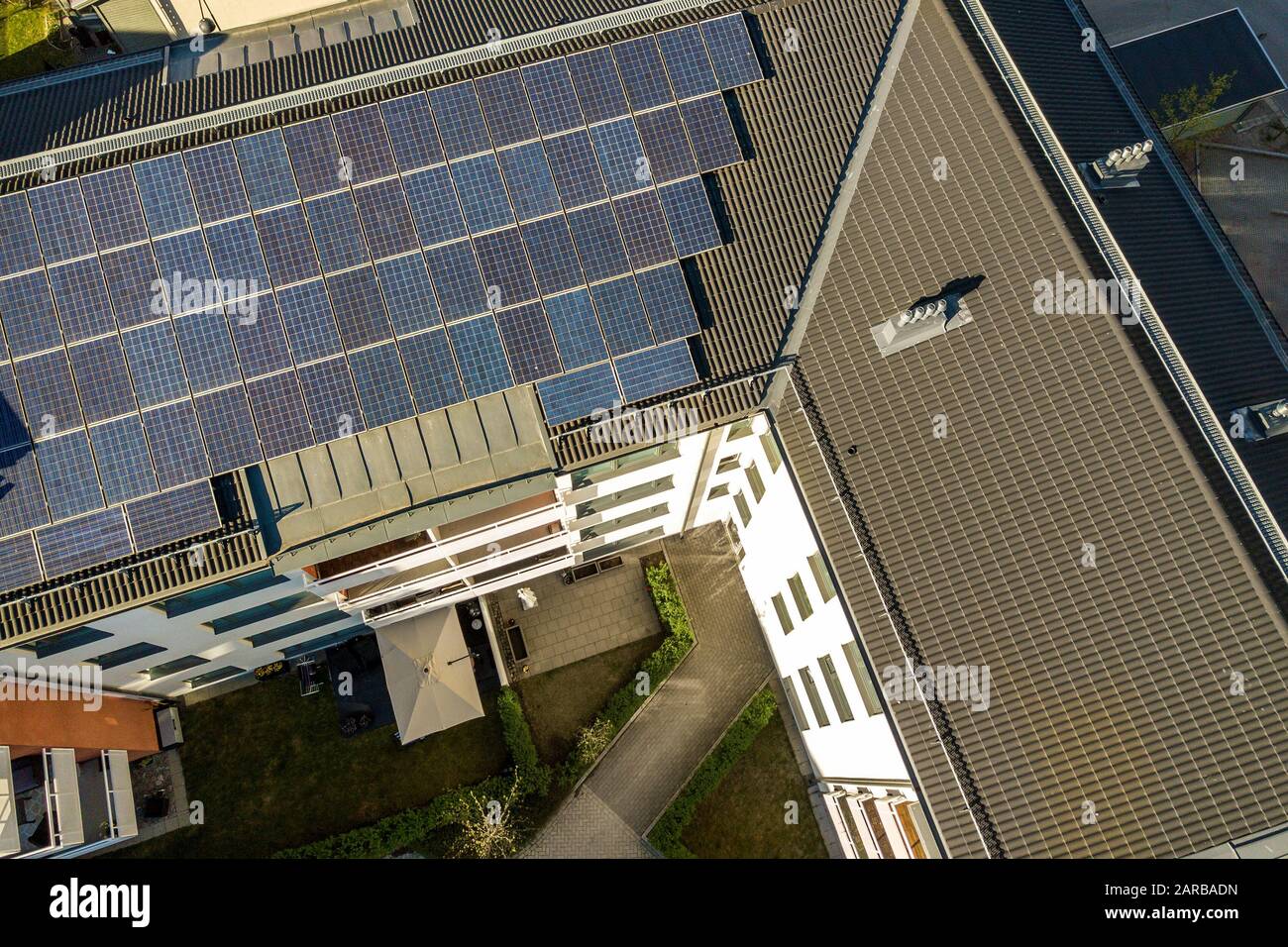 Aerial view of solar photovoltaic panels on a roof top of residential ...