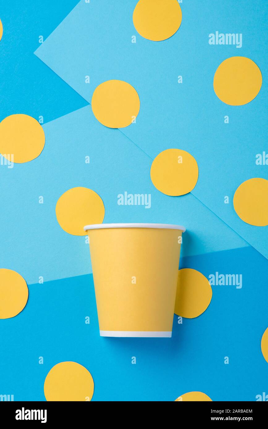 Yellow paper cup for a party on a bright blue background Stock Photo ...