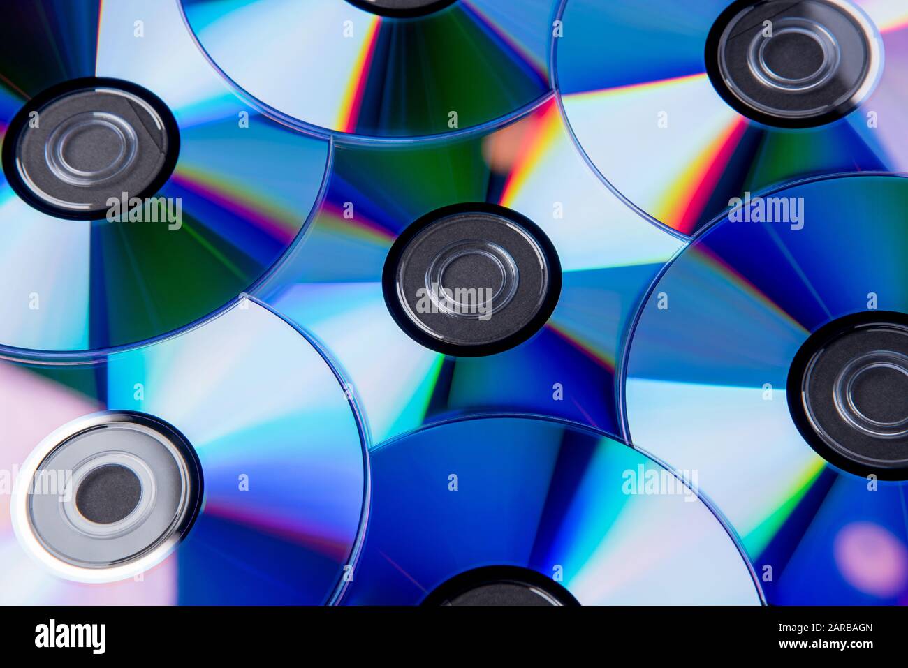 Many musical clean compact discs with a rainbow spectrum of colors as a ...