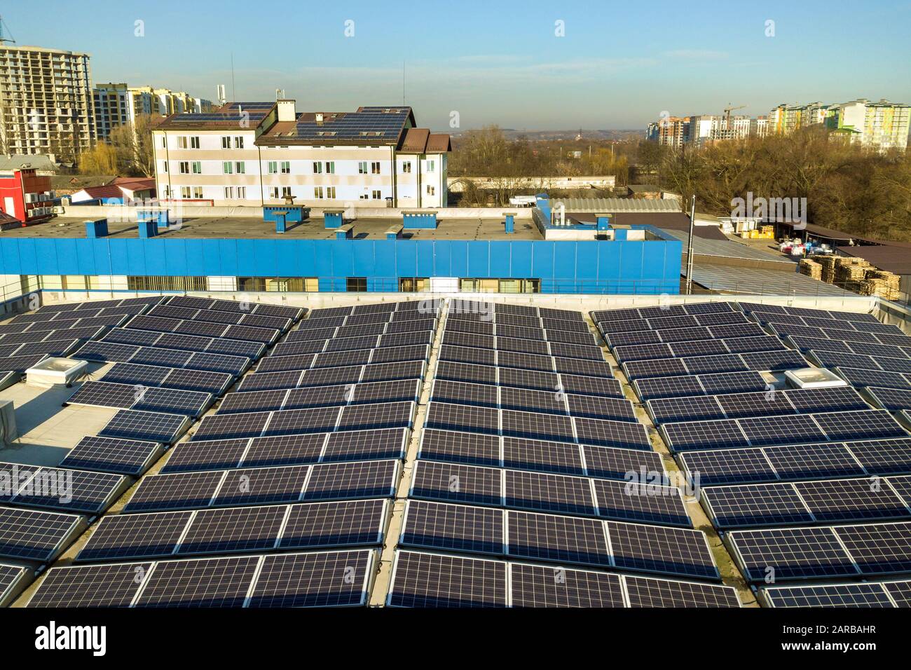Aerial view of many photo voltaic solar panels mounted of industrial ...