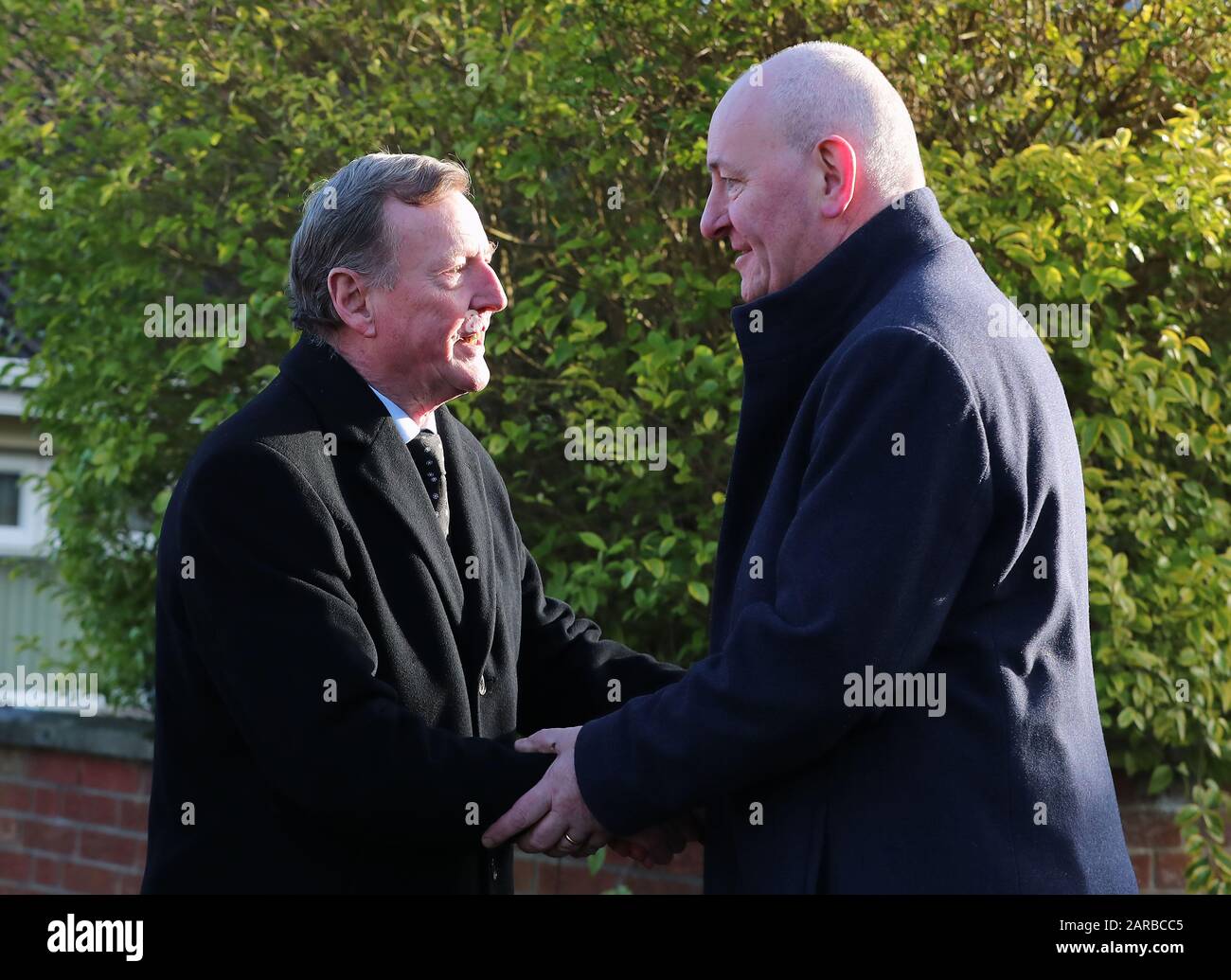 Former Stormont first minister Lord David Trimble (left) is greeted by ...