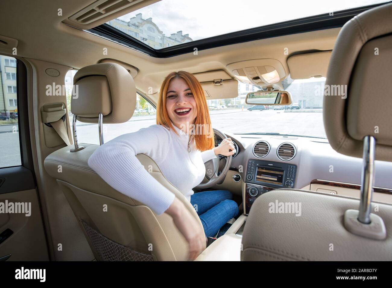 Woman driving reversing car looking hi-res stock photography and images ...