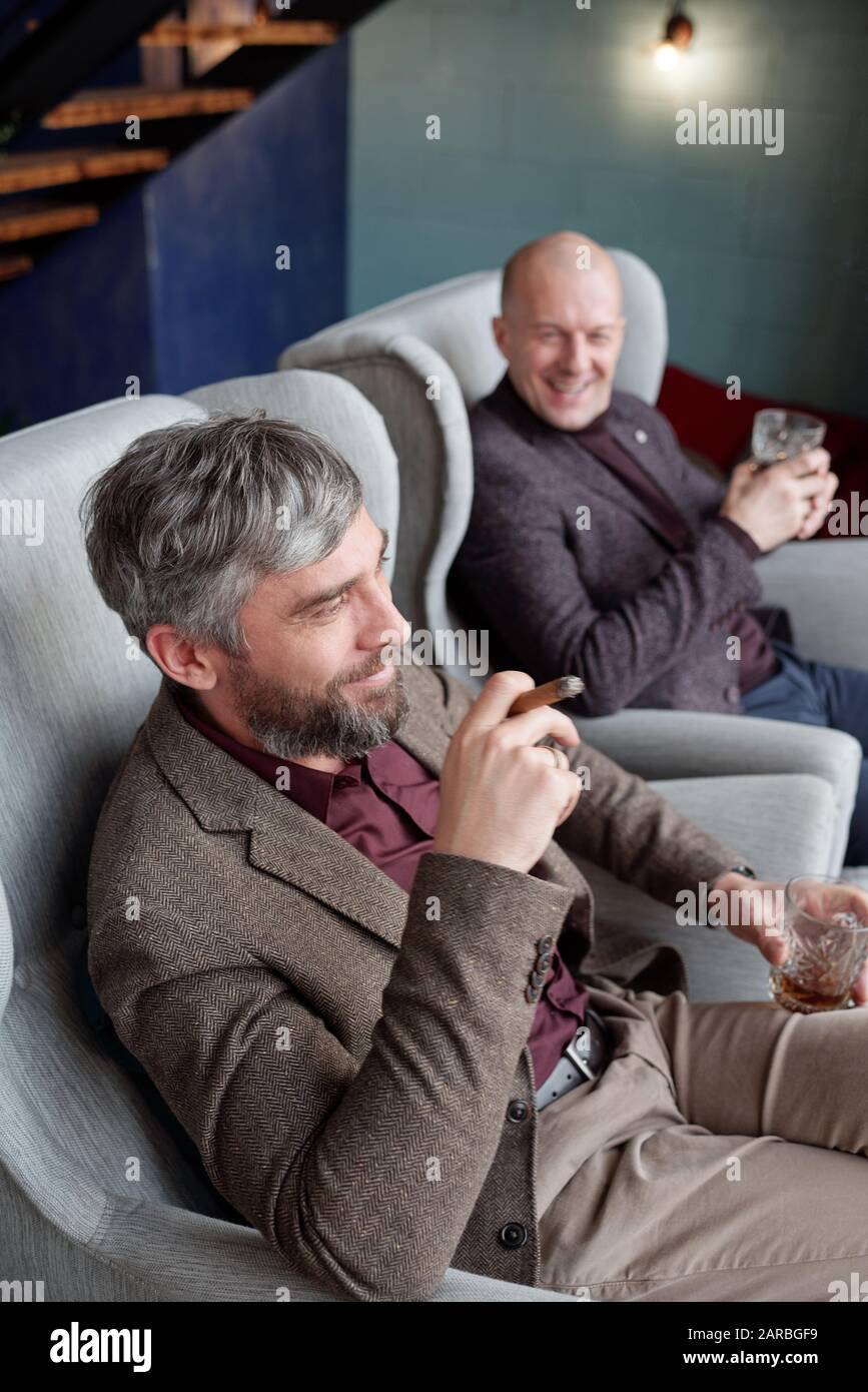 Rich men smoking cigars Stock Photo - Alamy