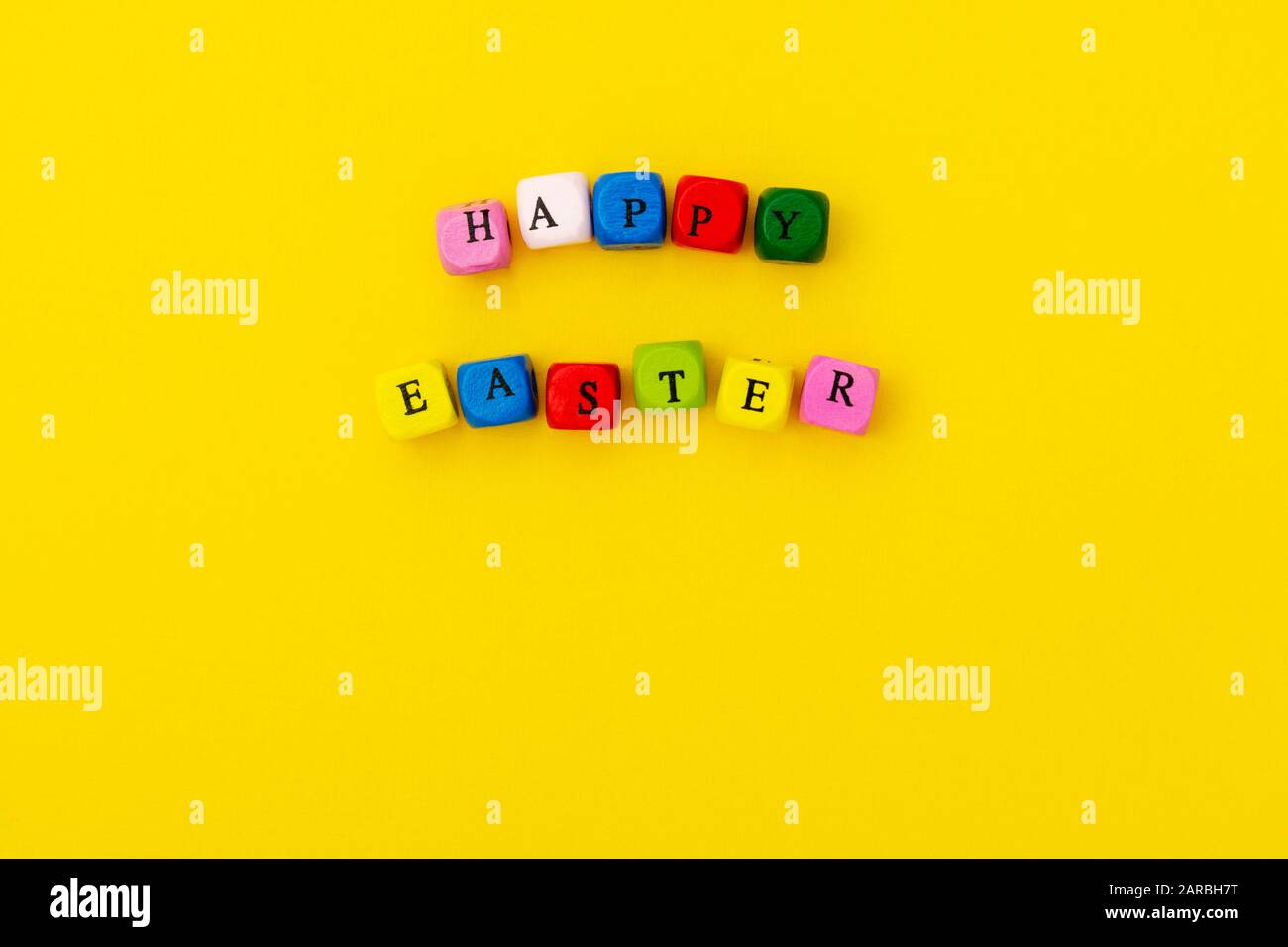 Happy Easter. Cubes with text on yellow background. Ready greating card ...