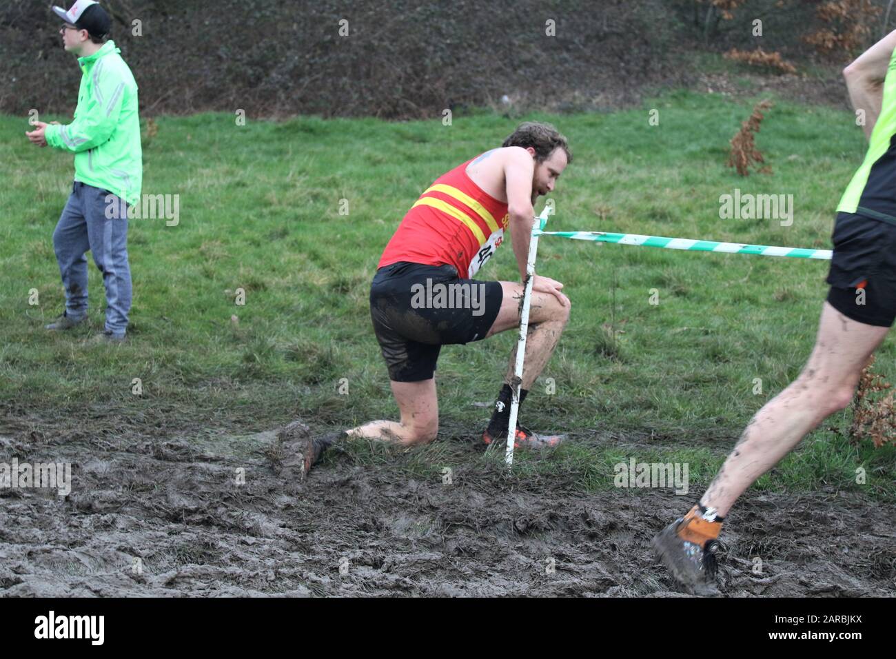 runners getting to feet after slipping over on cross country running ...
