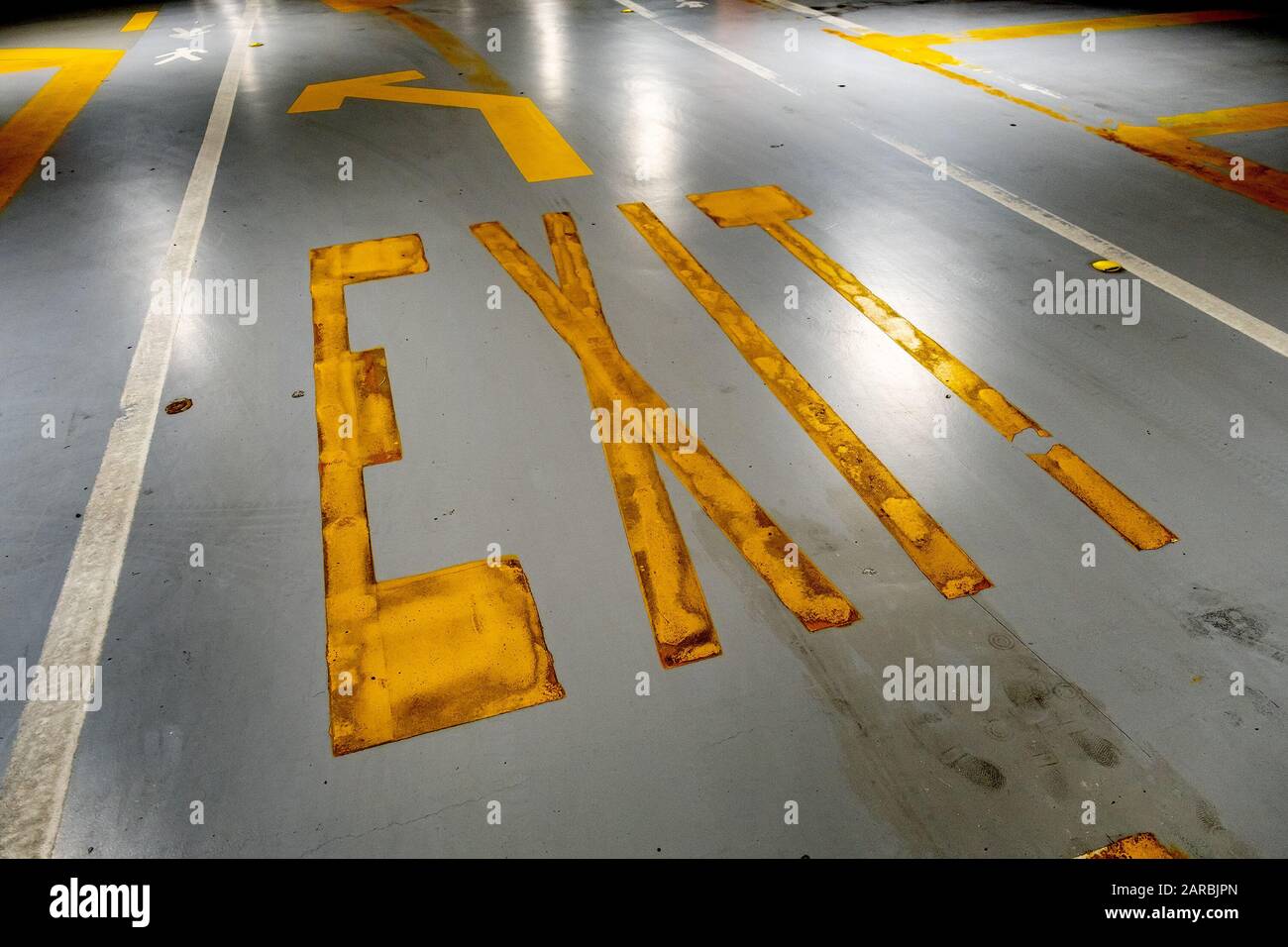 Exit sign painted on the floor of underground parking lot Stock Photo ...