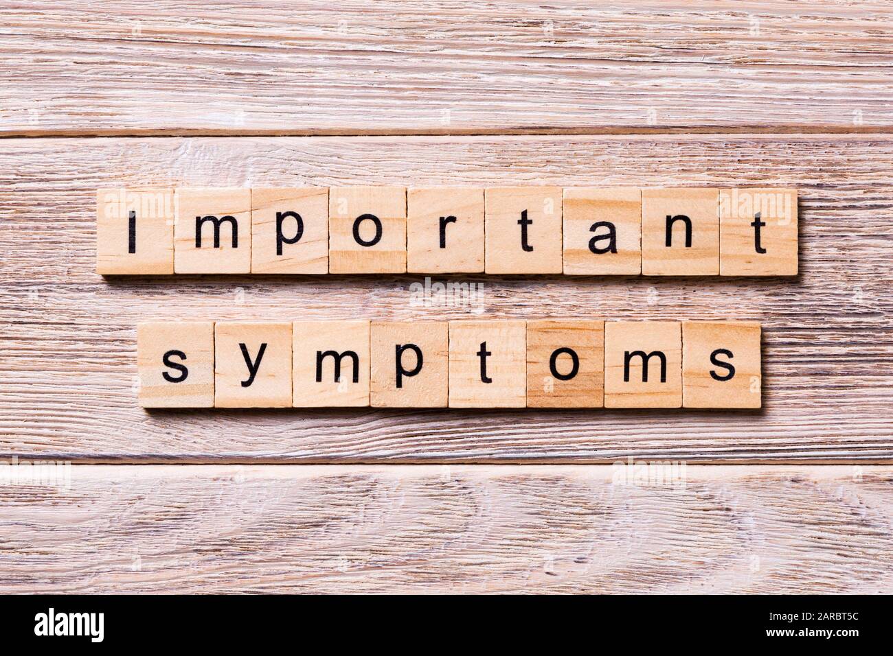 important symptoms word written on wood block. important symptoms text ...
