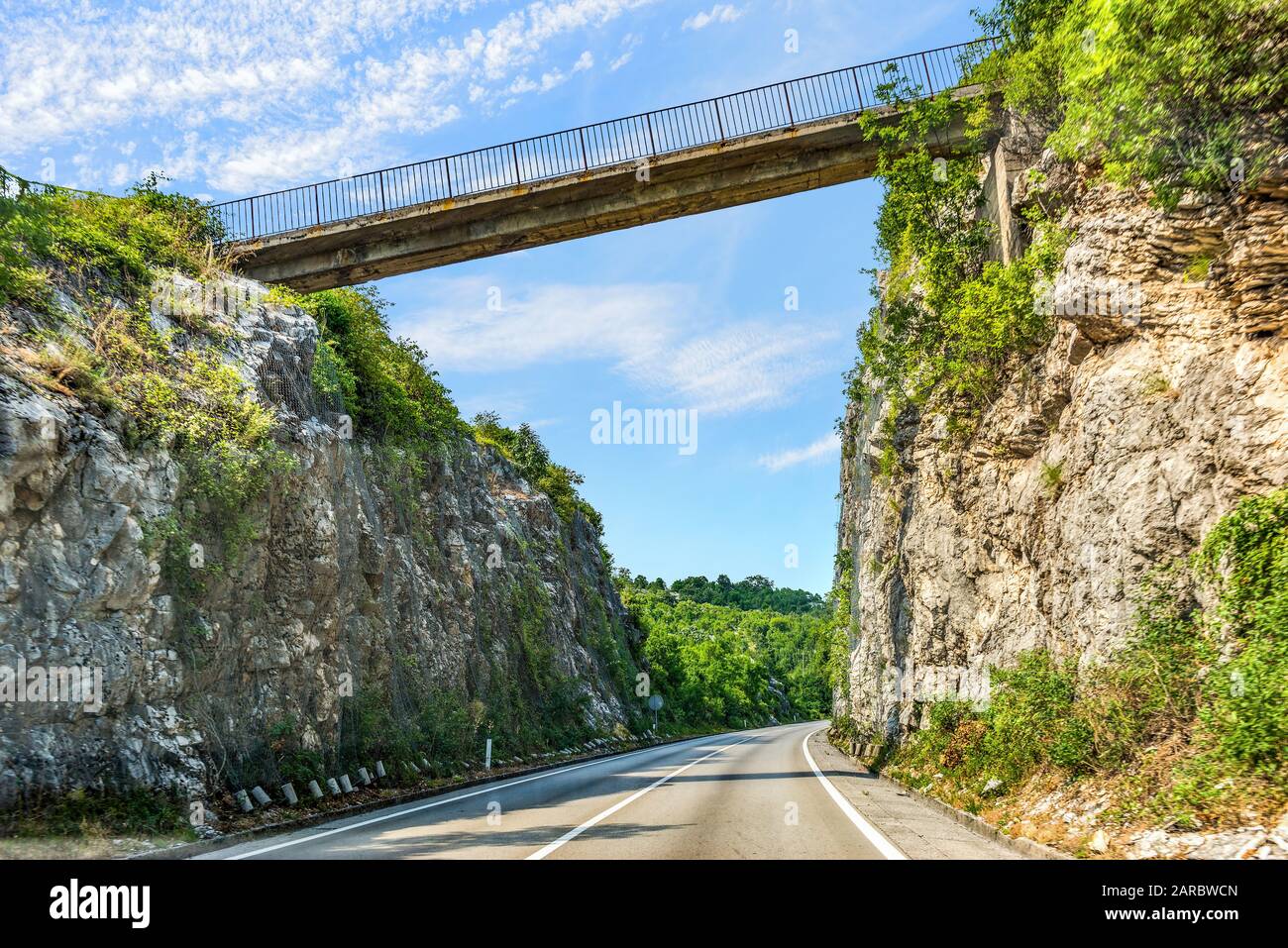 Road through mountains under connecting bridge in Montenegro Stock ...