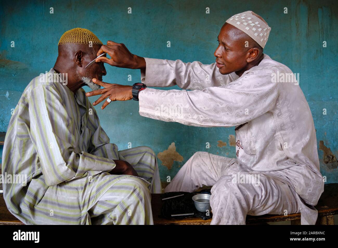 Muslim man shaving the Imam of his mosque with a razor blade Stock ...