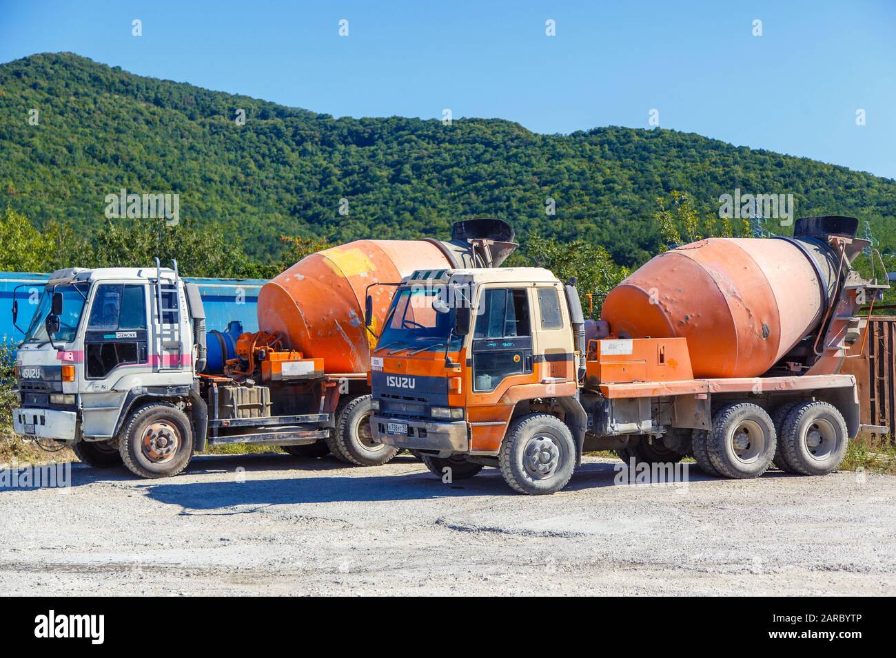 Concrete trucks on the construction site. Cars are not new, the dusty ...