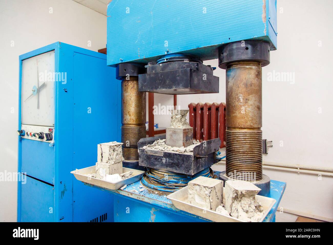 Construction laboratory. The press breaks down the cubic concrete ...