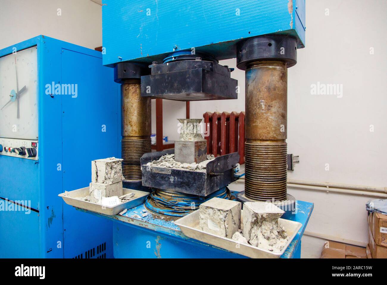 Construction laboratory. The press breaks down the cubic concrete ...