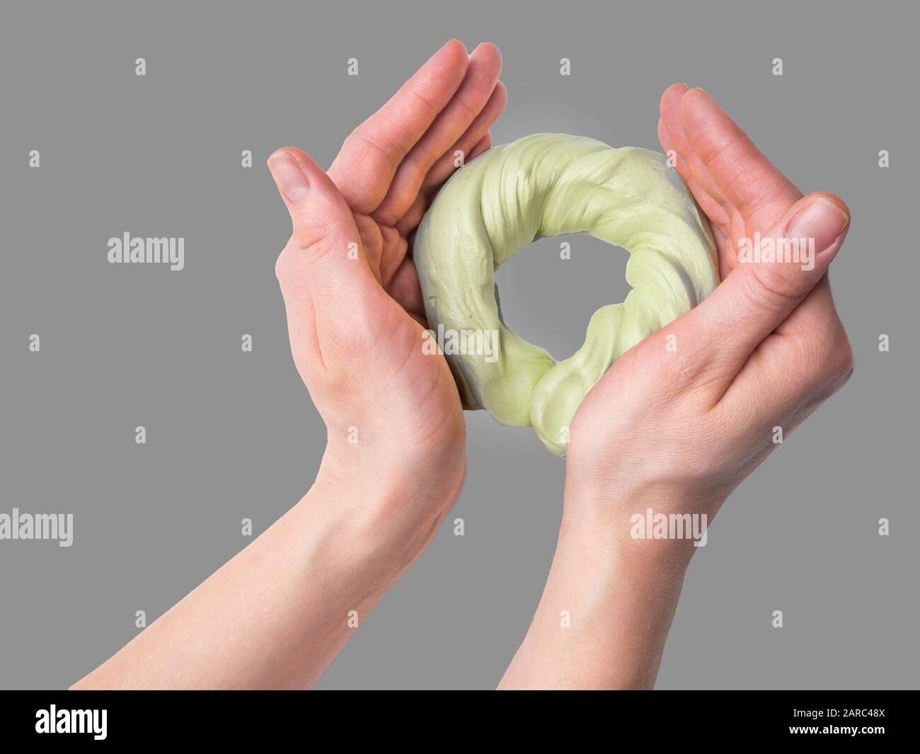 Sticky slime in the hand. The green slime in hands. Favorite toy for a ...