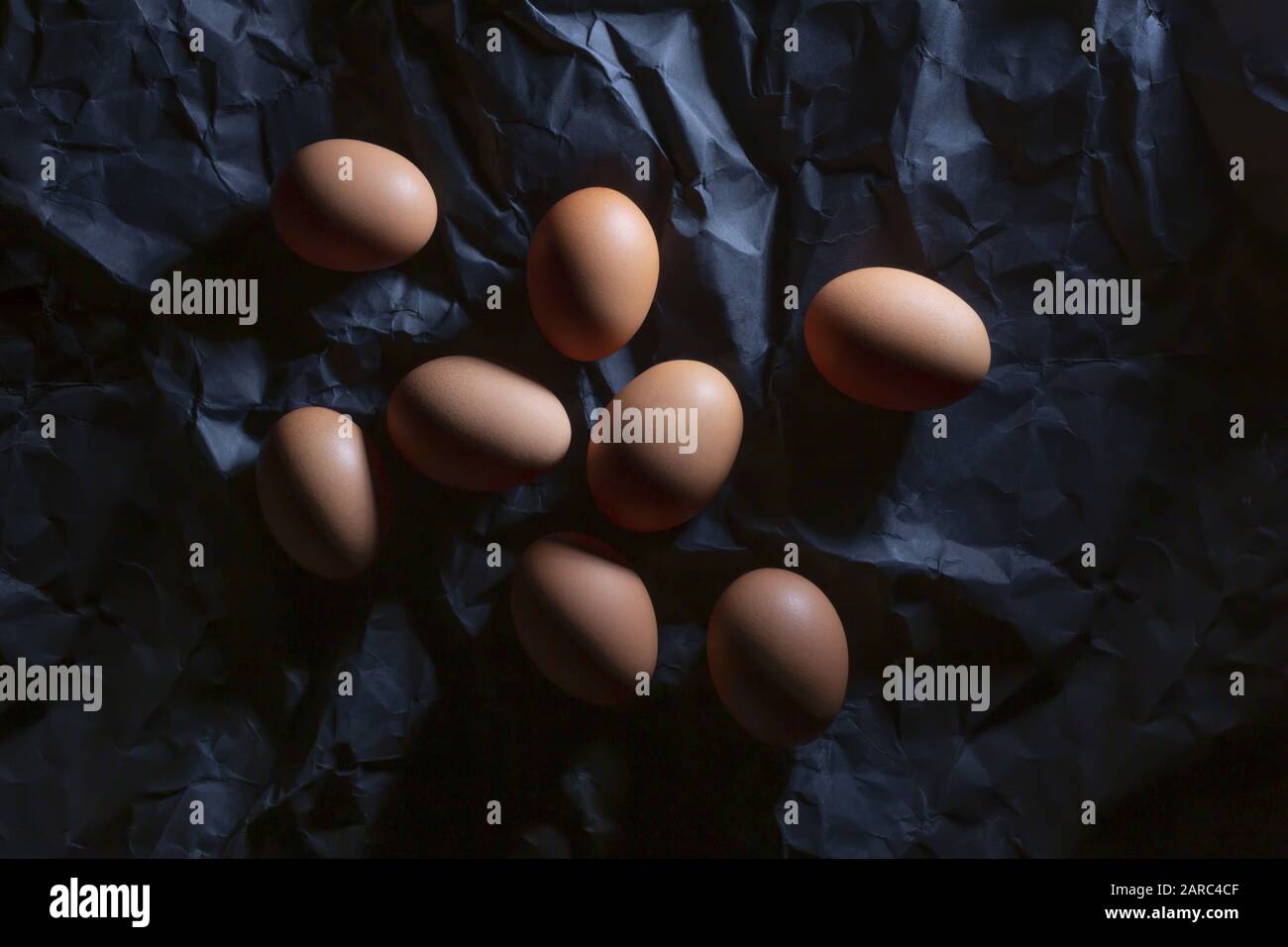 Eight eggs for coloring on a crumpled dark Stock Photo - Alamy