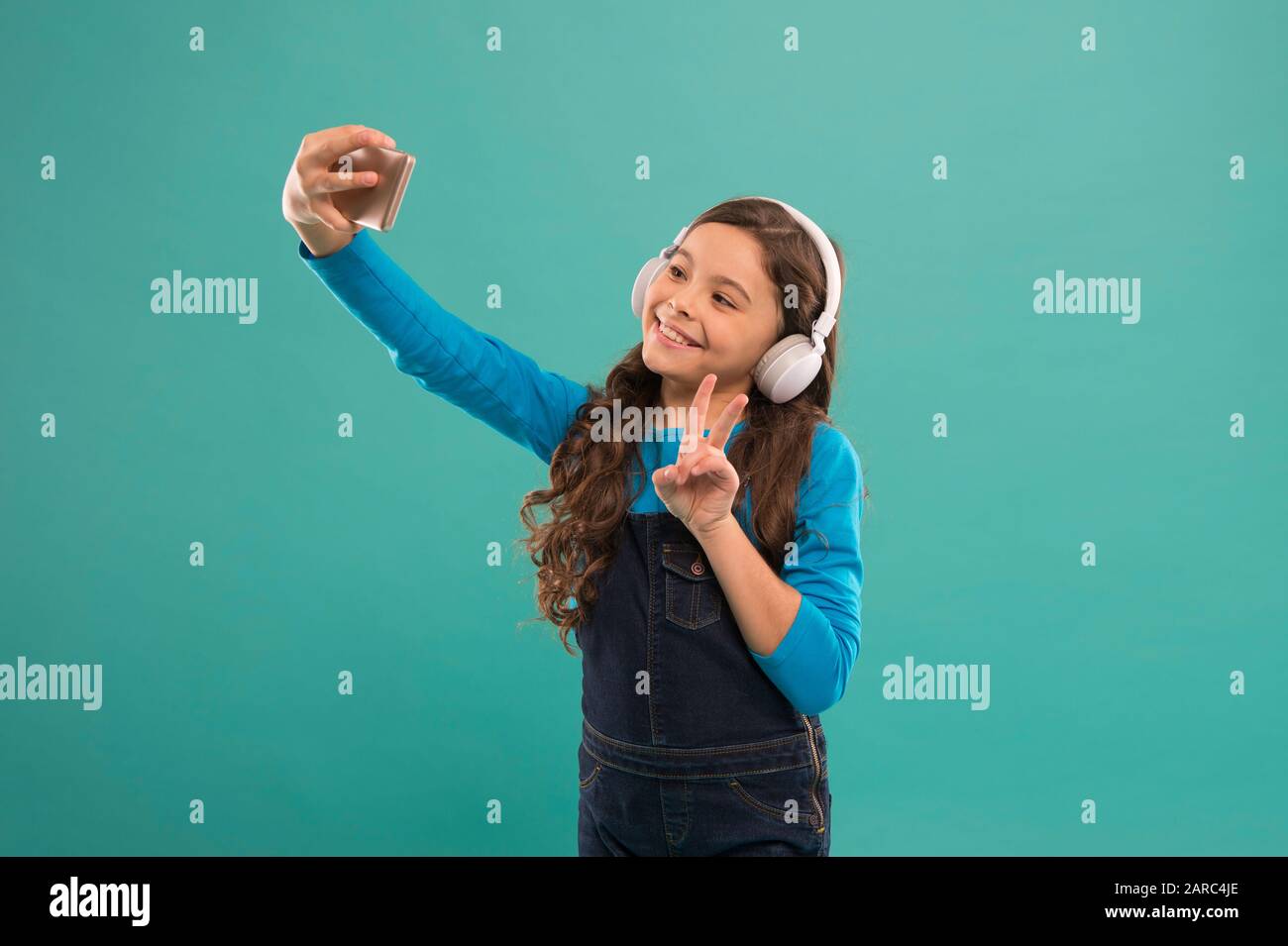 Hello world. Video call. Small girl child with smartphone. Small girl ...