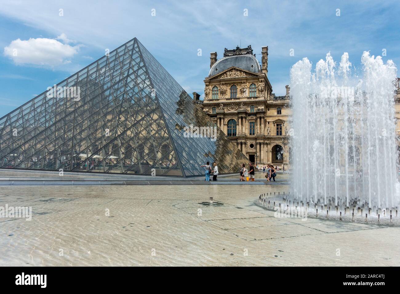 Entrance pyramid and fountain on Cour Napoléon (courtyard) with ...