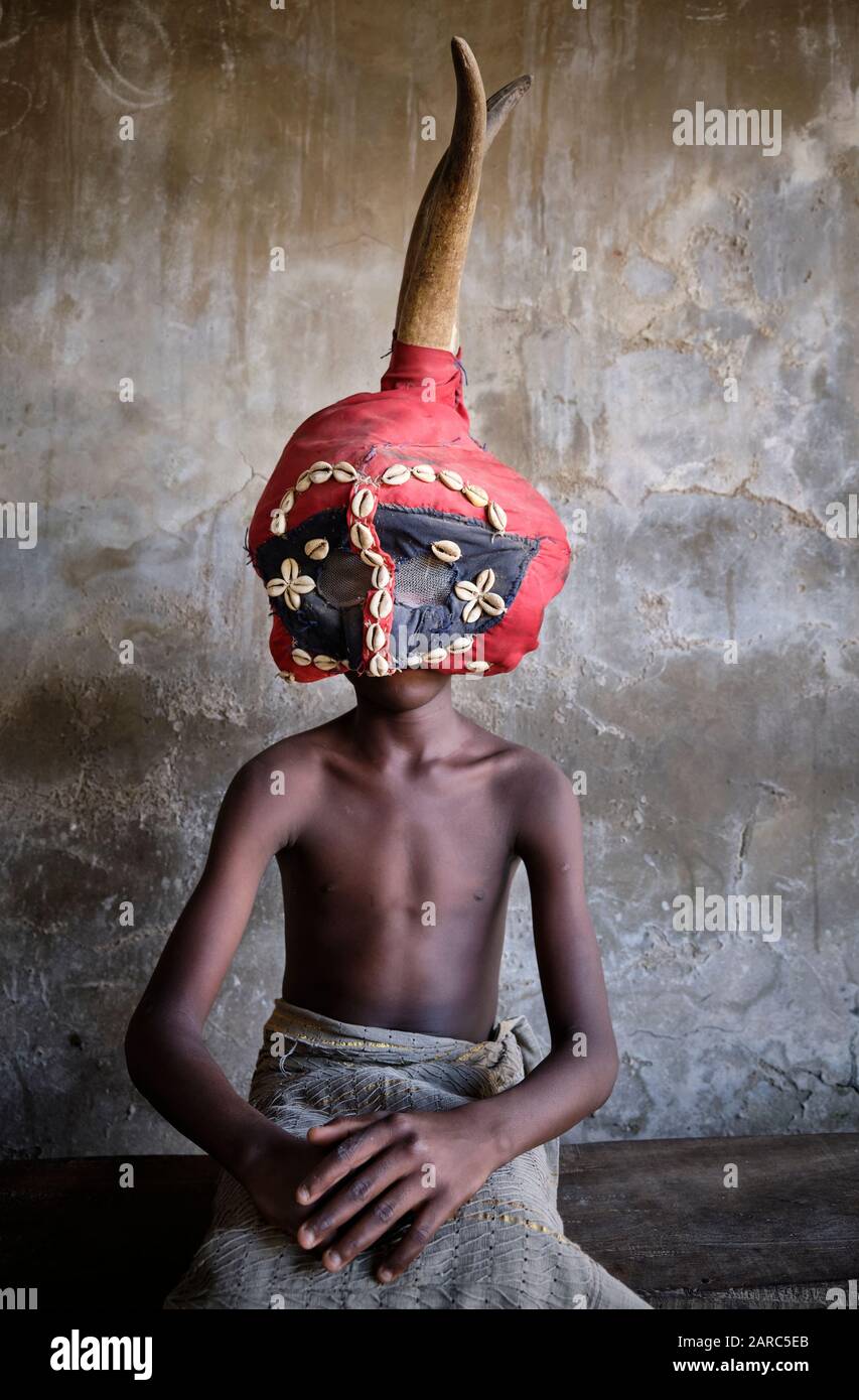 Boy in a traditional ceremonial costume of the Yoruba religion. The ...
