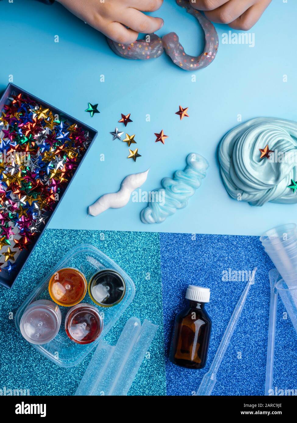 Components to make slime. Child education concept. On blue surface ...