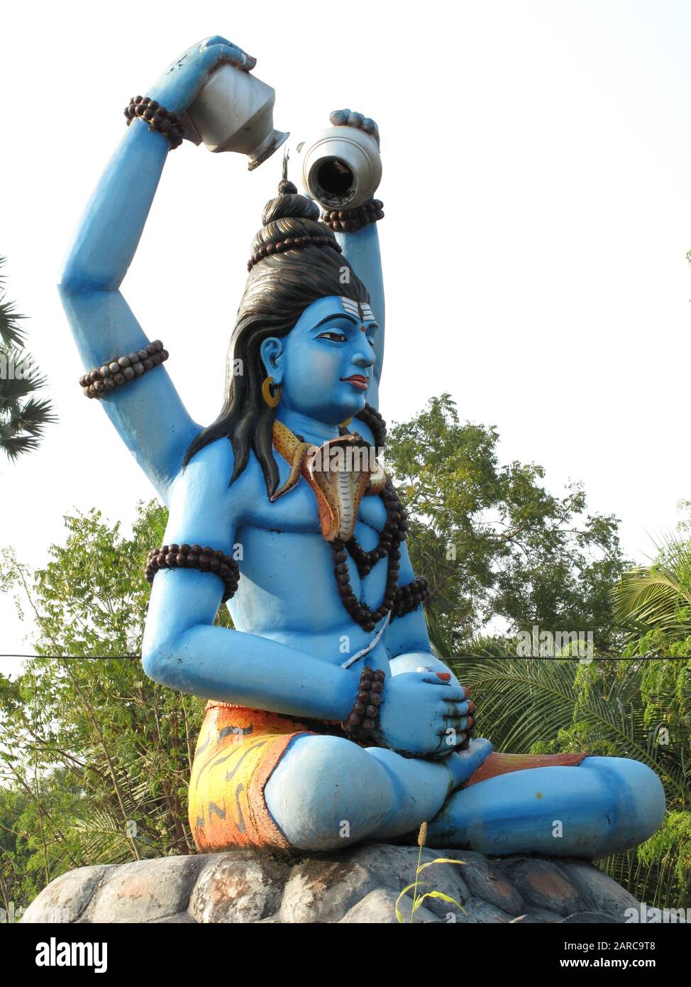 Vertical shot of a Hindu god statue on a rock Stock Photo - Alamy