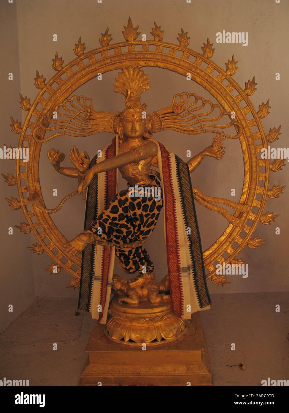Vertical shot of a golden Hindu statue Stock Photo - Alamy