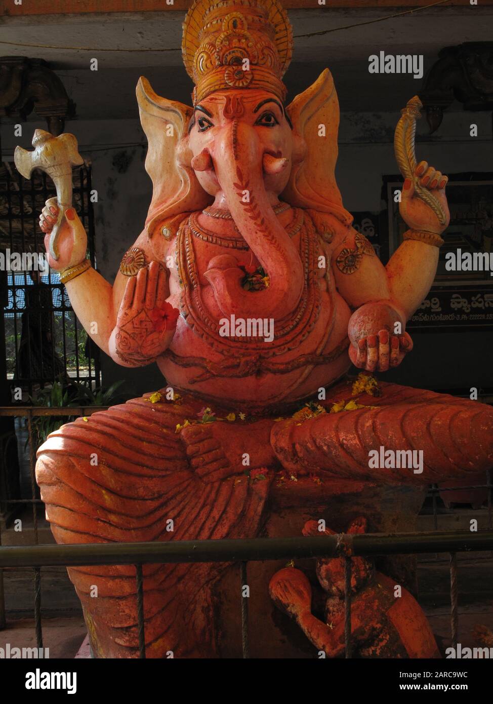 Vertical shot of a Hindu god statue behind a metal railing Stock Photo ...