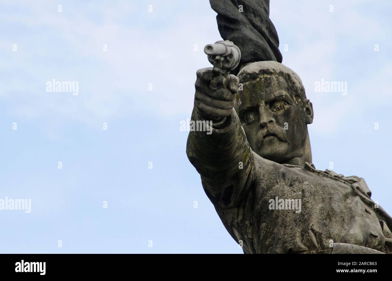 Closeup shot of a statue of a man pointing a gun Stock Photo - Alamy