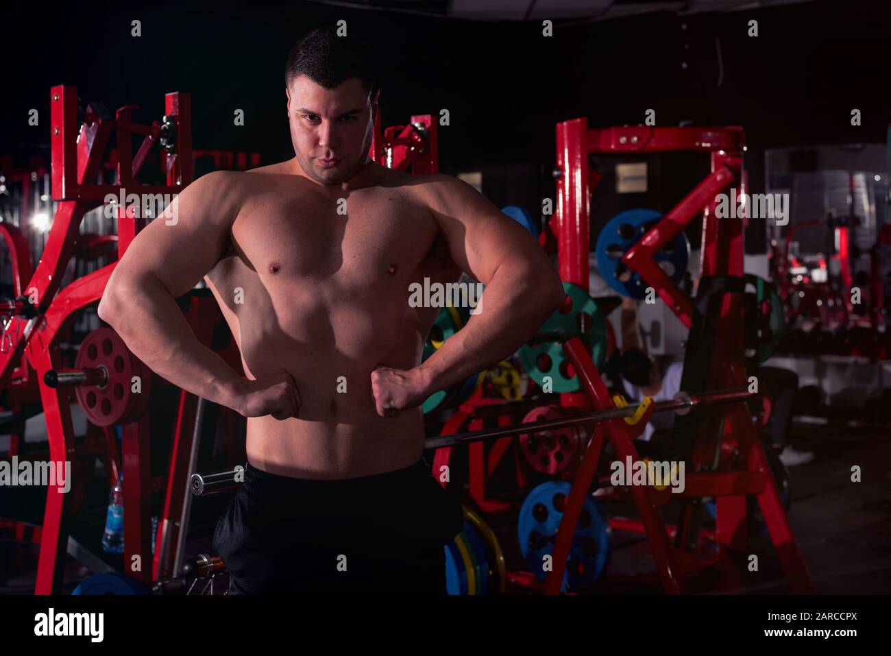 Fitness model Man posing in the gym. Handsome man with big muscles ...
