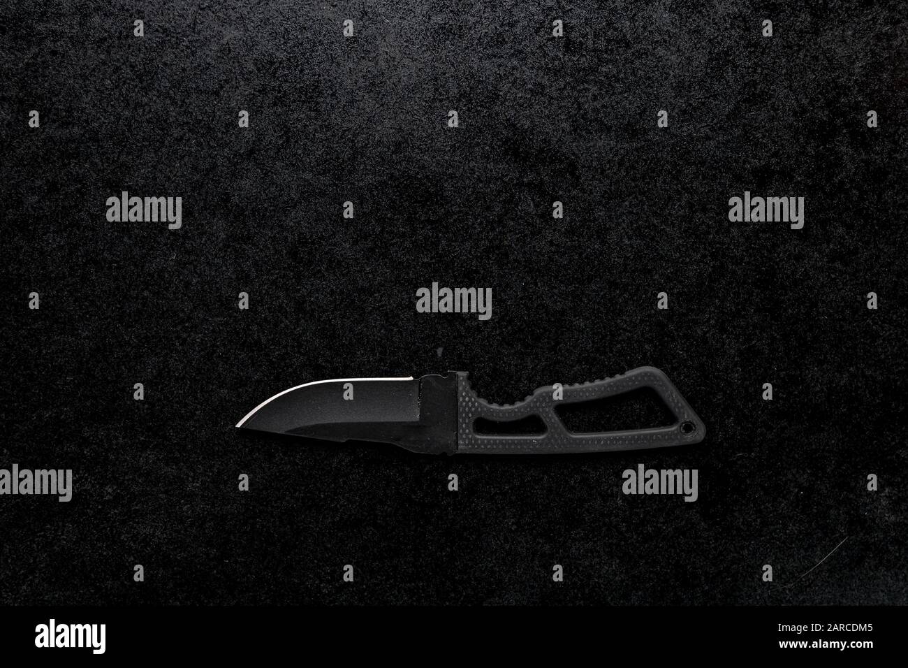 Black sharp small knife with black handle Stock Photo - Alamy