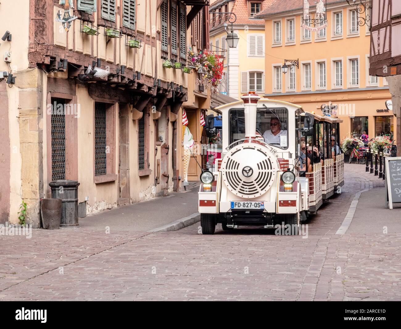 Tourists on tour train trip in the streets of Colmar Alsace France ...