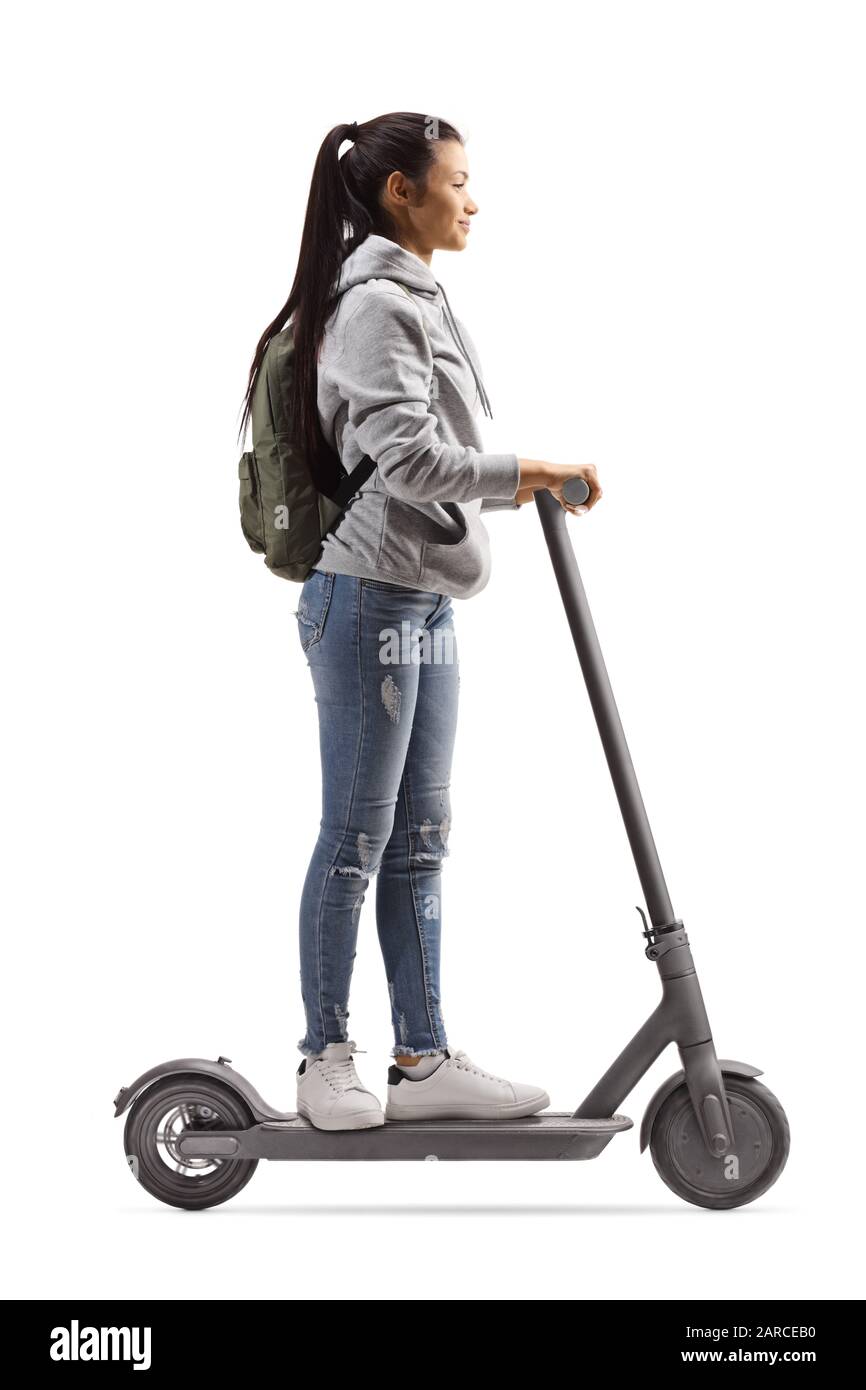 Full length profile shot of a female student with a backpack riding an ...