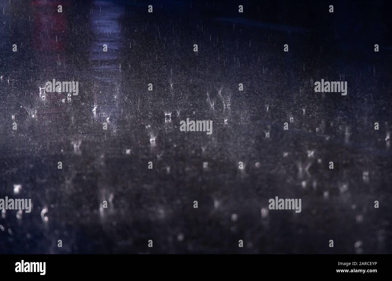 Droplets of water hitting the ground during rain Stock Photo - Alamy