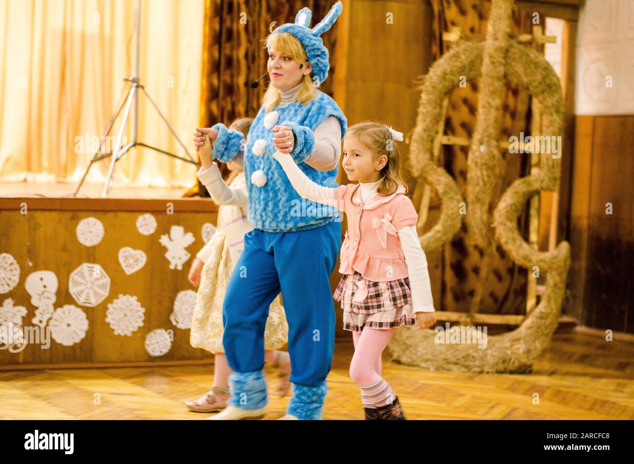 Children's Christmas New Year's concert. Children play with Snow Maiden ...