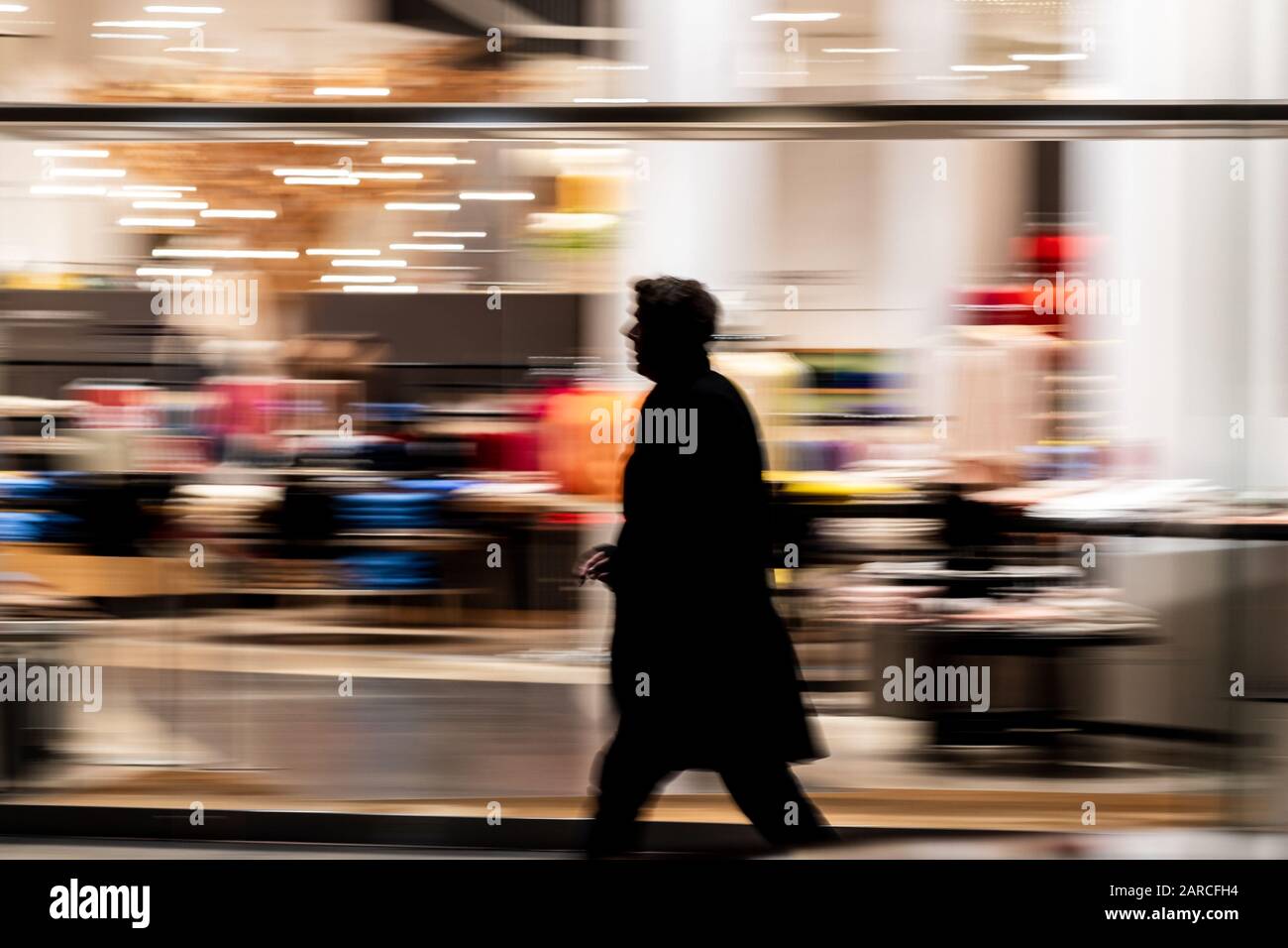 Wide angle shot of a person rushing through a room full of items Stock ...