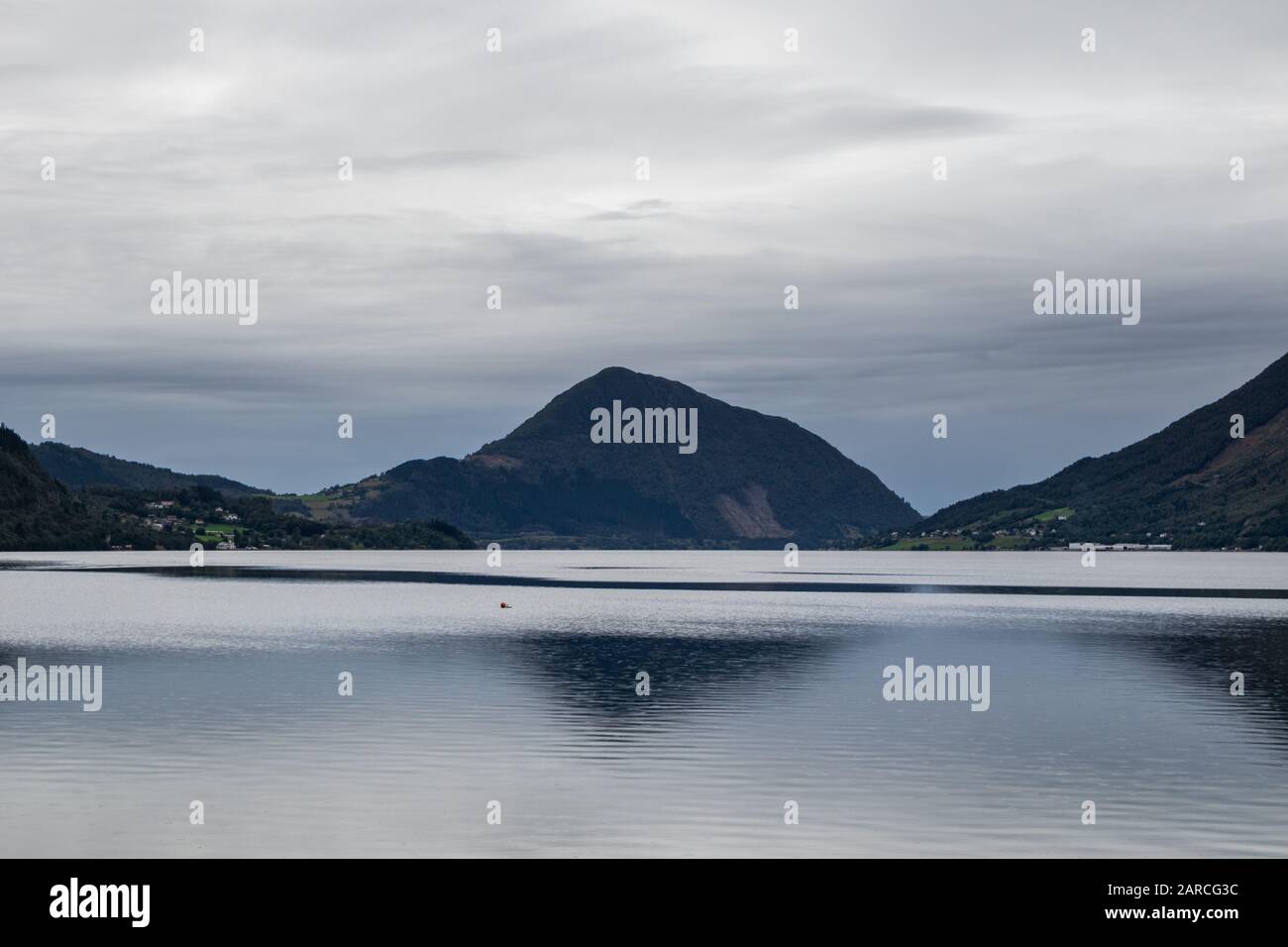 Cold grey color Norway landscape on fjord coast with cold water ...
